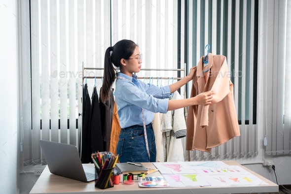 Women fashion designer stylist working and thinking decide making new ...