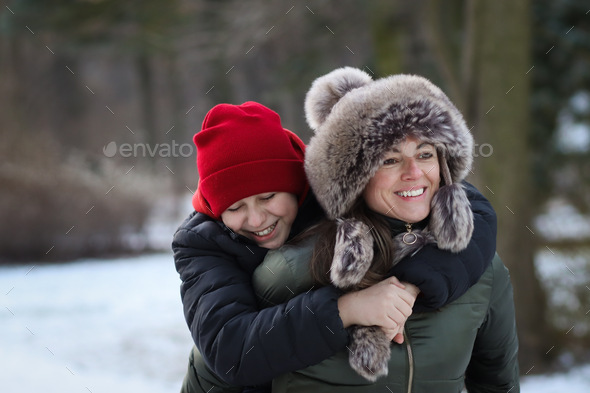 Mom and son having fun in the park in winter. Stock Photo by NatalieZera