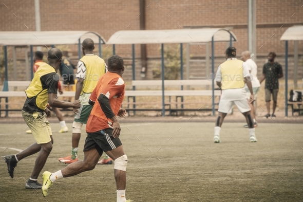 Football players or soccer player run fast and kick a soccer ball on a ...