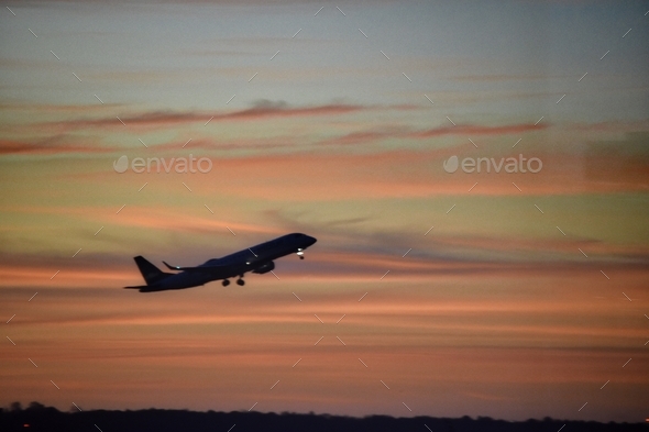 Plane taking off at sunset or sunrise Stock Photo by Malisunshine ...