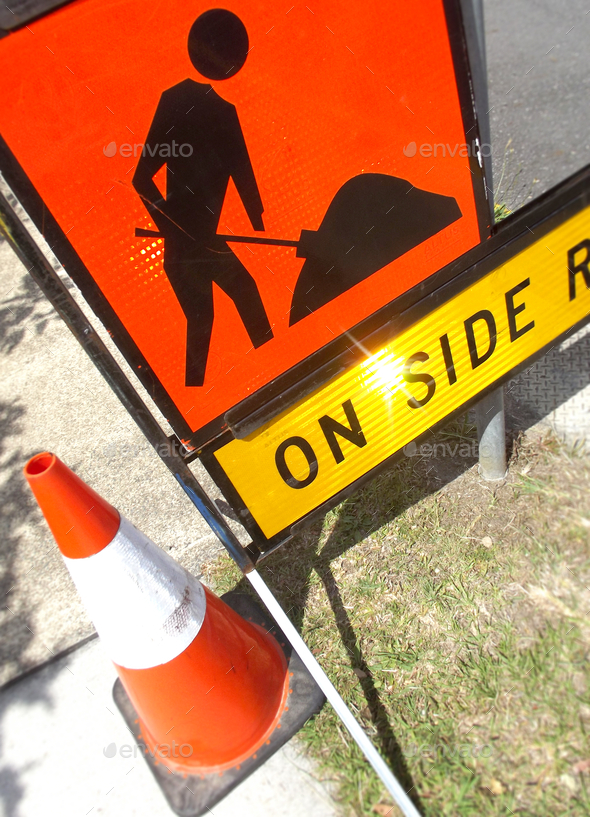 Men at work roadside signage and a traffic cone Stock Photo by ...