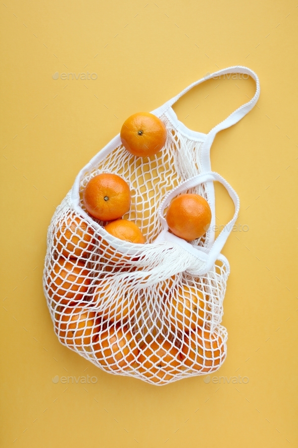 Oranges in a white reusable string shopping bag - eco friendly ...