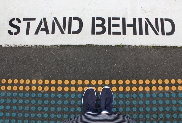 Stand behind the yellow line on the train station platform Stock Photo ...