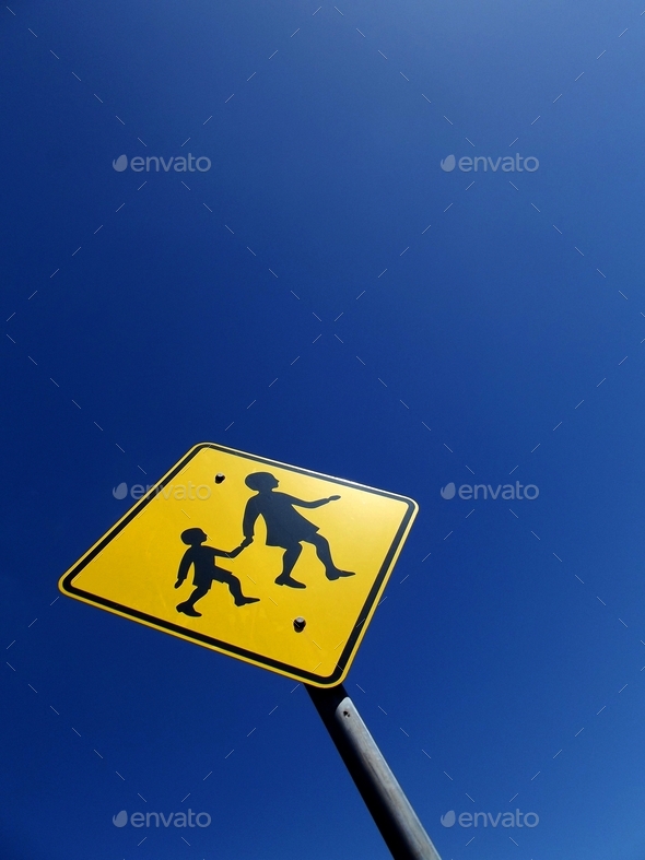 Children crossing near a school safety sign Stock Photo by iheartcreative
