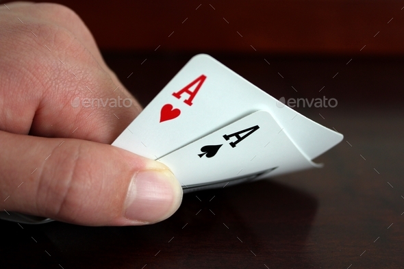 A hand of playing cards with an Ace of Hearts and an Ace of Spades ...
