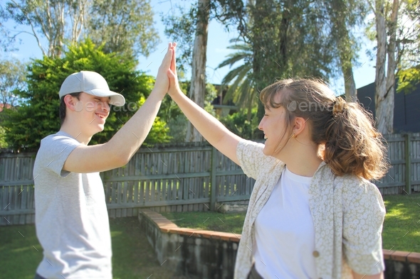 Generation Z teenager siblings high five each other Stock Photo by ...