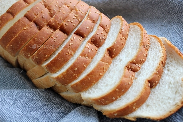 Loaf of fresh sliced bread with sesame seed crust Stock Photo by ...