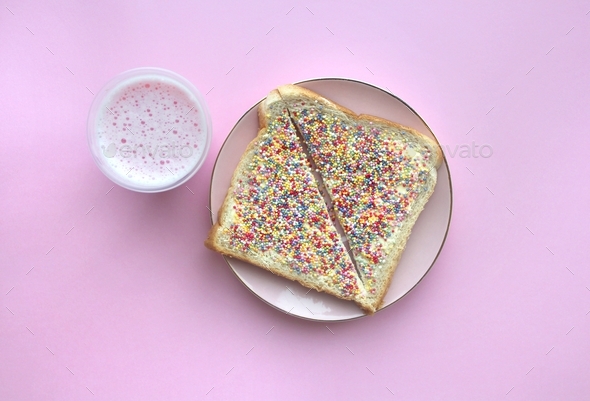 Fairy bread on a pink plate and a pink background with a strawberry ...