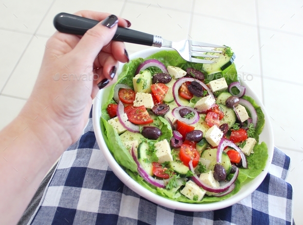 Healthy food on my lap for lunch, Greek salad with feta and olives ...
