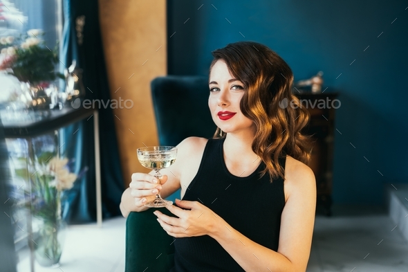 Posh woman drinking champagne in the luxury interior. Celebrity ...