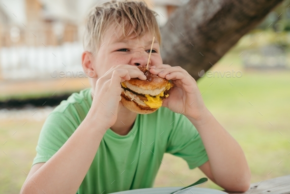 child eating burger Stock Photo by Yuliya_Kokosha | PhotoDune