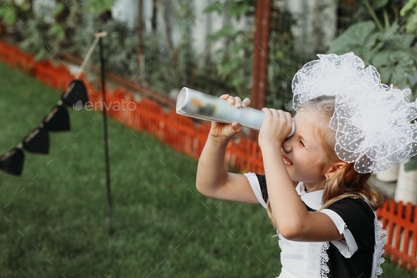 First grader little girl in the first day of training at the school ...