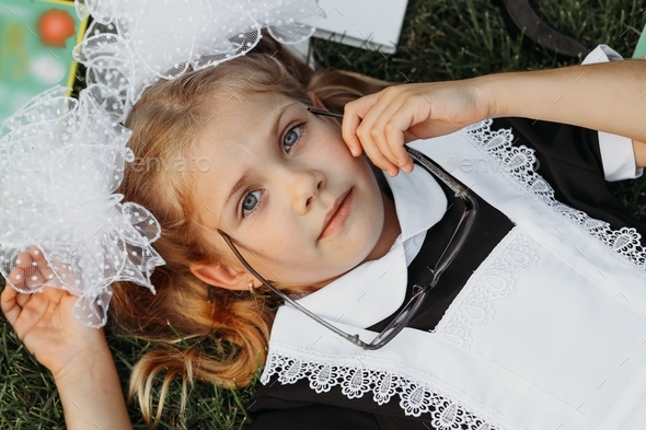 First grader little girl in the first day of training at the school ...