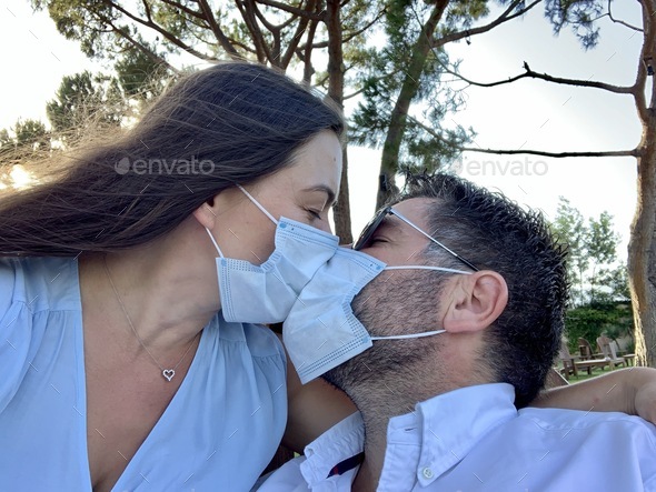 Social distancing. Couple kissing in favs masks. New normal Stock Photo ...