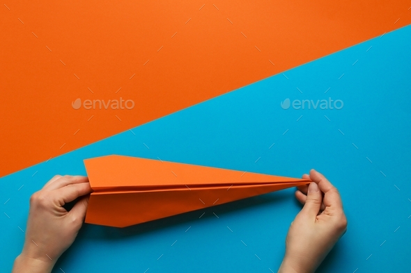Orange paper plane on blue and orange background. Origami hobby Stock ...