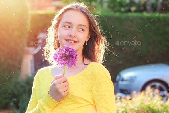 Nominated Close-up portrait of beautiful preteen girl holding purple ...