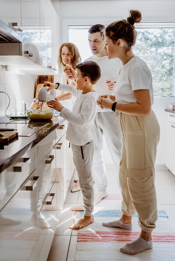 Happy family cooking at home together, weekend leisure activity, family ...