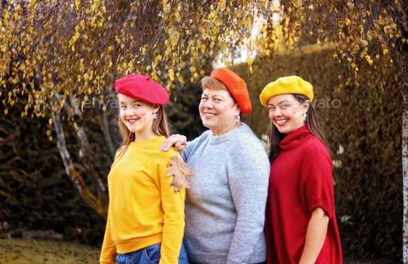 Mother, daughter and grandmother in bright colorful berets posing for ...