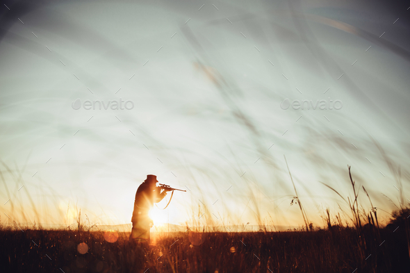 Hunter pointing his Gun on field Stock Photo by crieneimages | PhotoDune