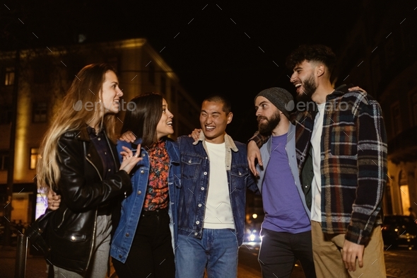 Group of friends laughing and having fun on a night out in town Stock ...