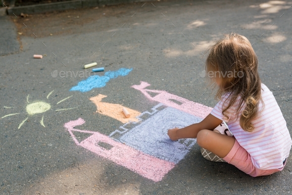 Children chalk drawing a castle outside Stock Photo by TGordievskaya