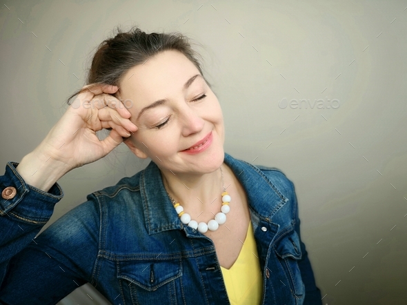 Happy face of mature woman smiling to her own thoughts, pleasure ...
