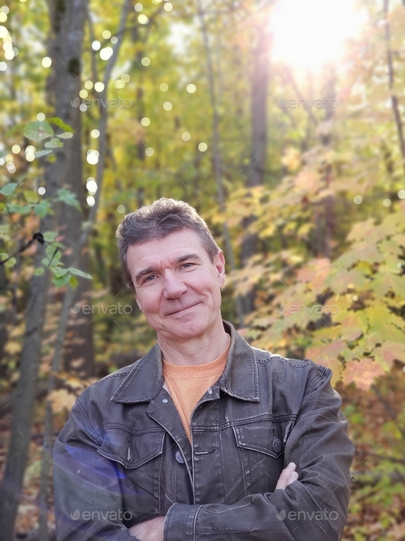 Happy man smiling to camera standing outdoor in the forest Stock Photo ...