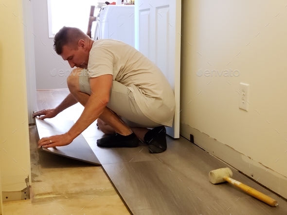 Floor level view of laminate flooring installation, home renovation ...