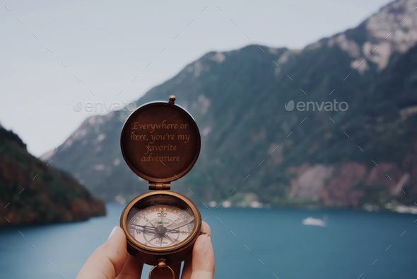 Open rustic compass pointing to the mountains for adventure travel ...