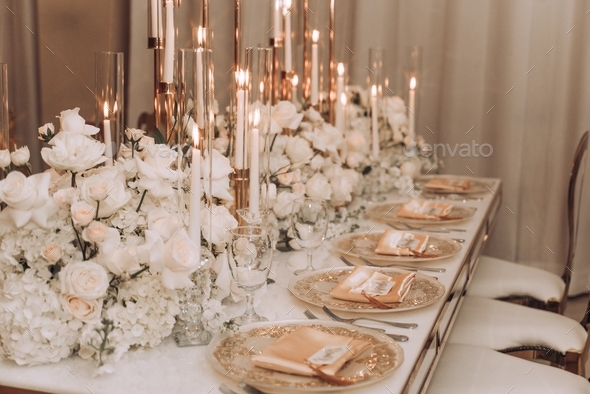 Elegant event table set up with floral arrangements and candlelight ...