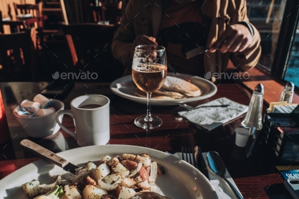 Man eating breakfast at restaurant pancakes and apple juice Stock Photo ...