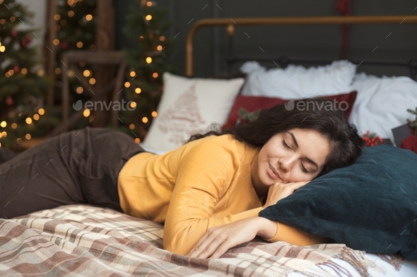 Beautiful lazy spanish woman lying on the bed at home on cozy bedroom ...