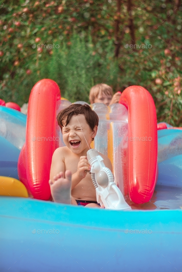Funny moment little kid boy shooting with water bluster in his face ...