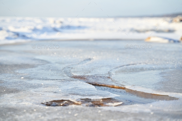 Spring landscape with clear sky and snow cover of ice and stream on ...