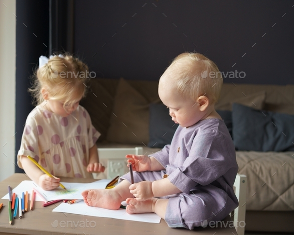 Two kids brother and sister drawing and playing together at home Stock ...