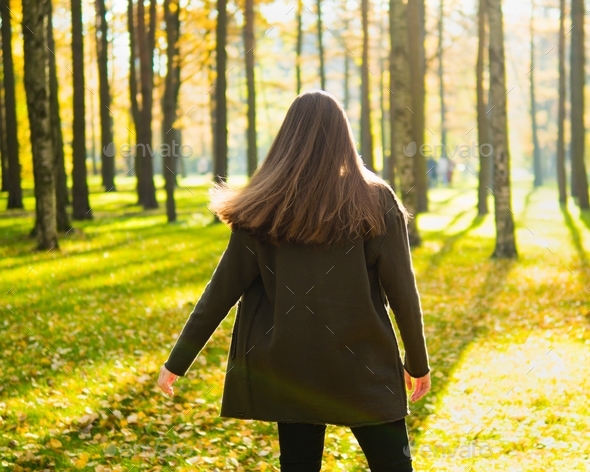 Woman walking in forest. One with nature. View from behind, back view ...