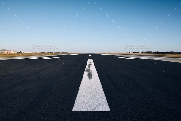 Surface level of airport runway with road marking against clear sky ...