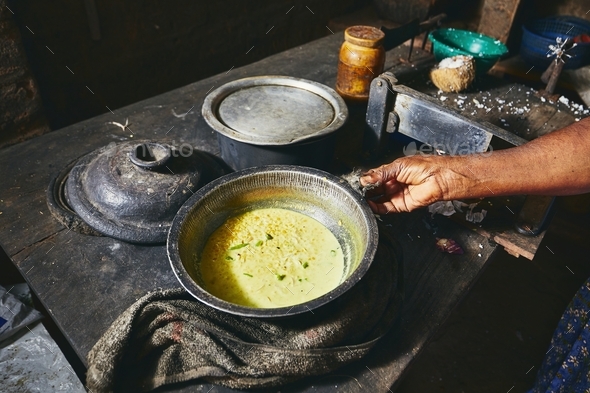 Preparation rice and curry meal. Woman preparing food in traditional ...