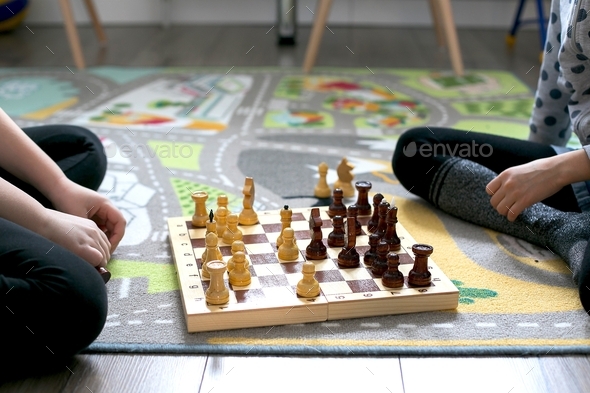 Two girls play chess in a children's room. Stock Photo by Anikona ...