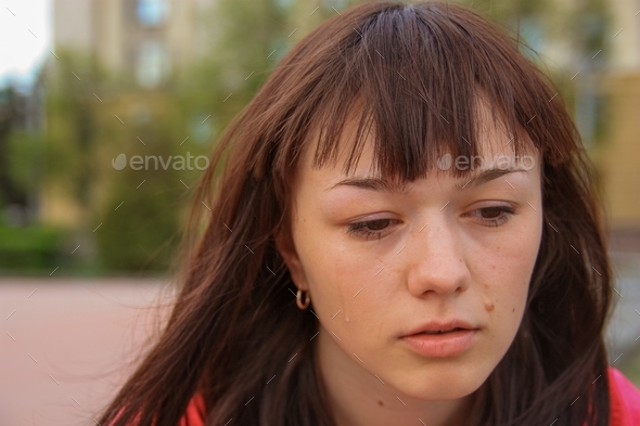crying asian young woman outdoors in summer Stock Photo by loskyt7