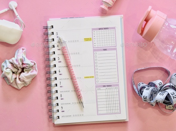 Overhead view of a weekly planner on a pink background Stock Photo by ...