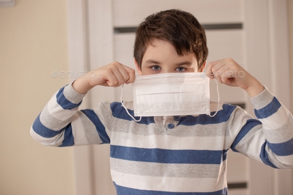 young boy with face protected with medical mask holds in his han Stock ...
