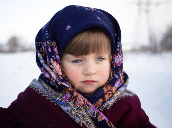 Russian beautiful girl in a purple traditional headscarf on a winter ...