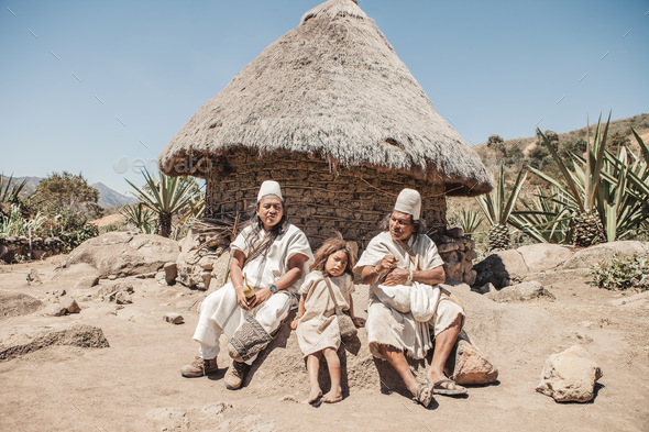 The grandfather, father and son of an indigenous family pose in front ...