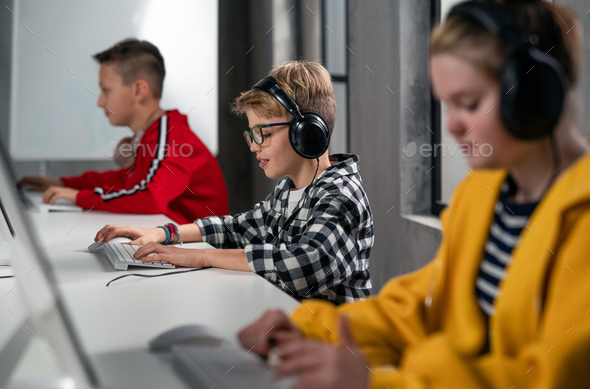 School kids using computer in classroom at school Stock Photo by halfpoint