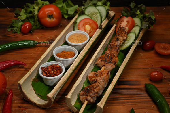 Grilled chicken meat in bamboo barrel plat served with Sichuan pepper ...