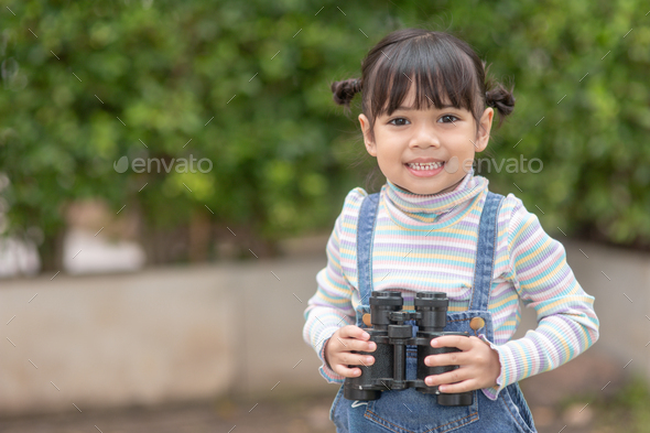 Happy kid looking ahead. Smiling child with the spyglass. Travel and ...