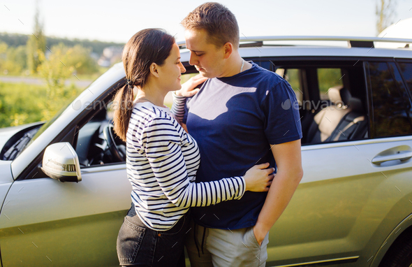 Smiling young couple inside a car. Kissing in the car Stock Photo by ...
