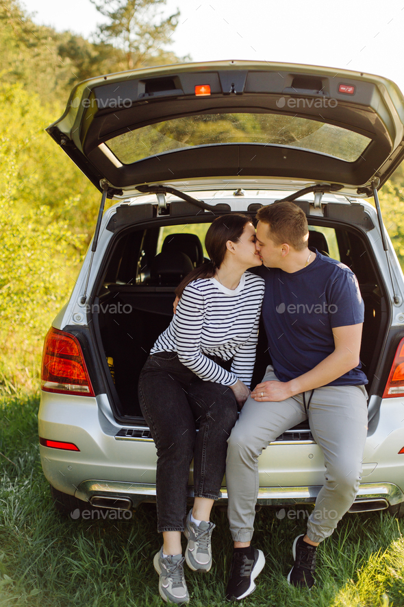 Smiling young couple inside a car. Kissing in the car Stock Photo by ...