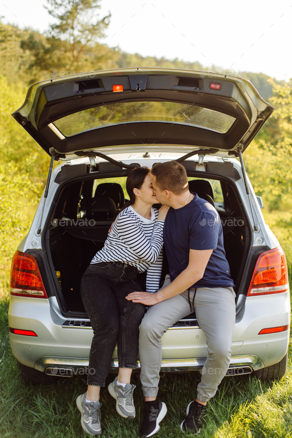 Smiling young couple inside a car. Kissing in the car Stock Photo by ...